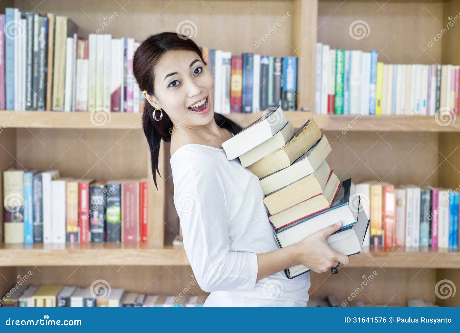 Attractive Female Bring Stack of Books in Library Stock Photo - Image ...