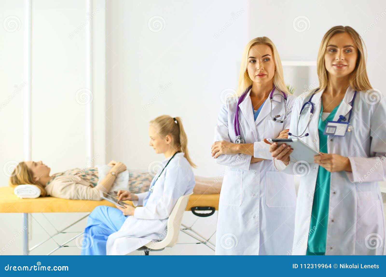 Attractive Female Doctor in Front of Medical Group Stock Photo - Image ...