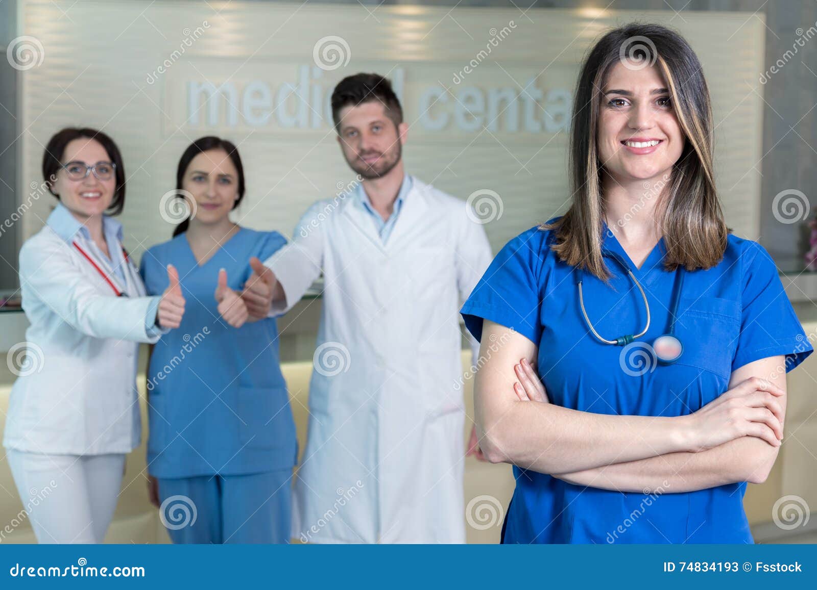 Attractive Female Doctor in Front of Medical Group . Stock Image ...