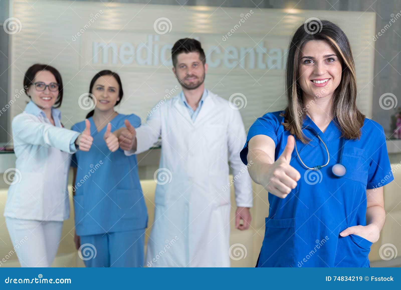 Attractive Female Doctor in Front of Medical Group . Stock Image ...