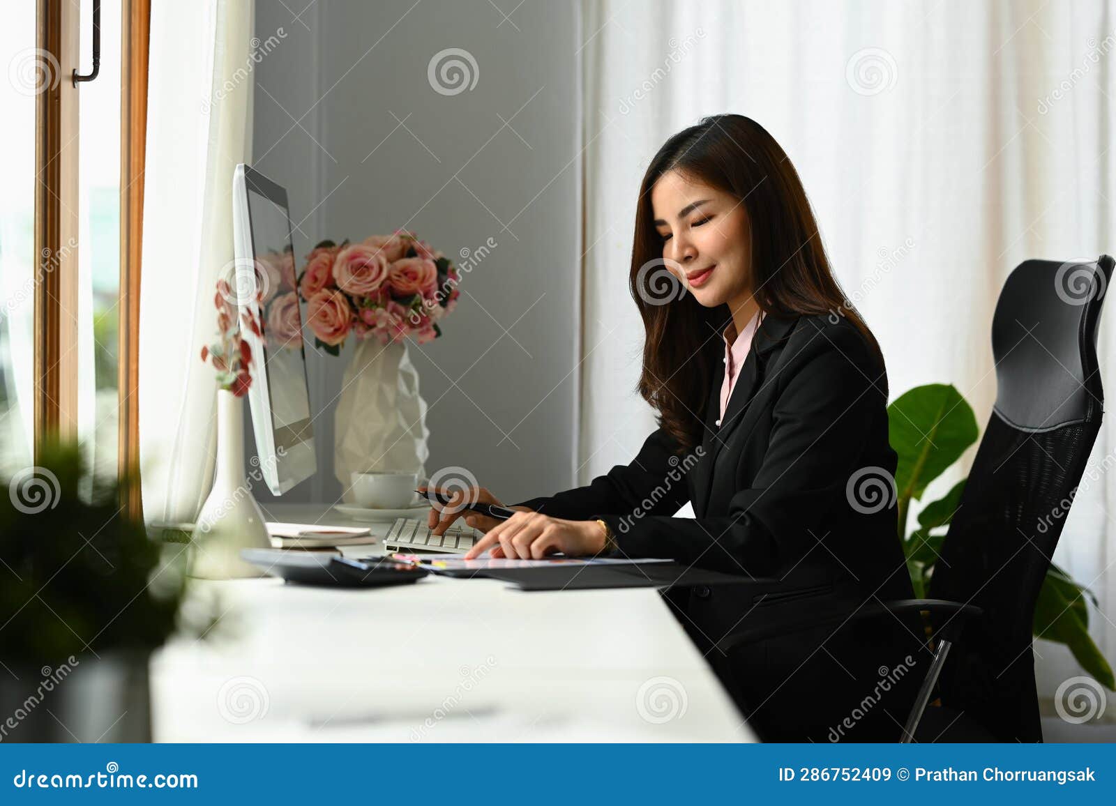 Attractive Female Economist Working with Graph and Statistic Document ...