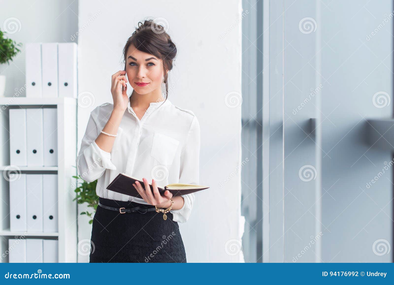 Attractive Female Employee Speaking on the Phone, Having Negotiations ...