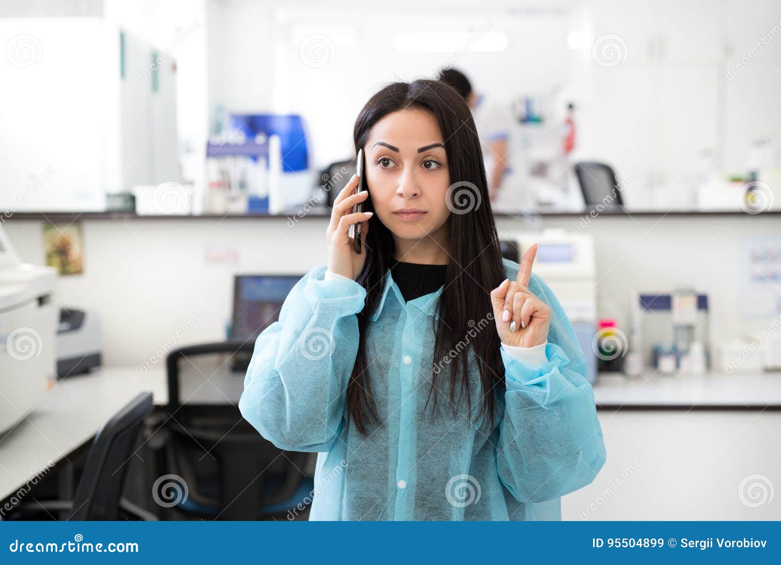 Attractive Female Lab Worker Using Mobile Phone at Her Workplace in the ...
