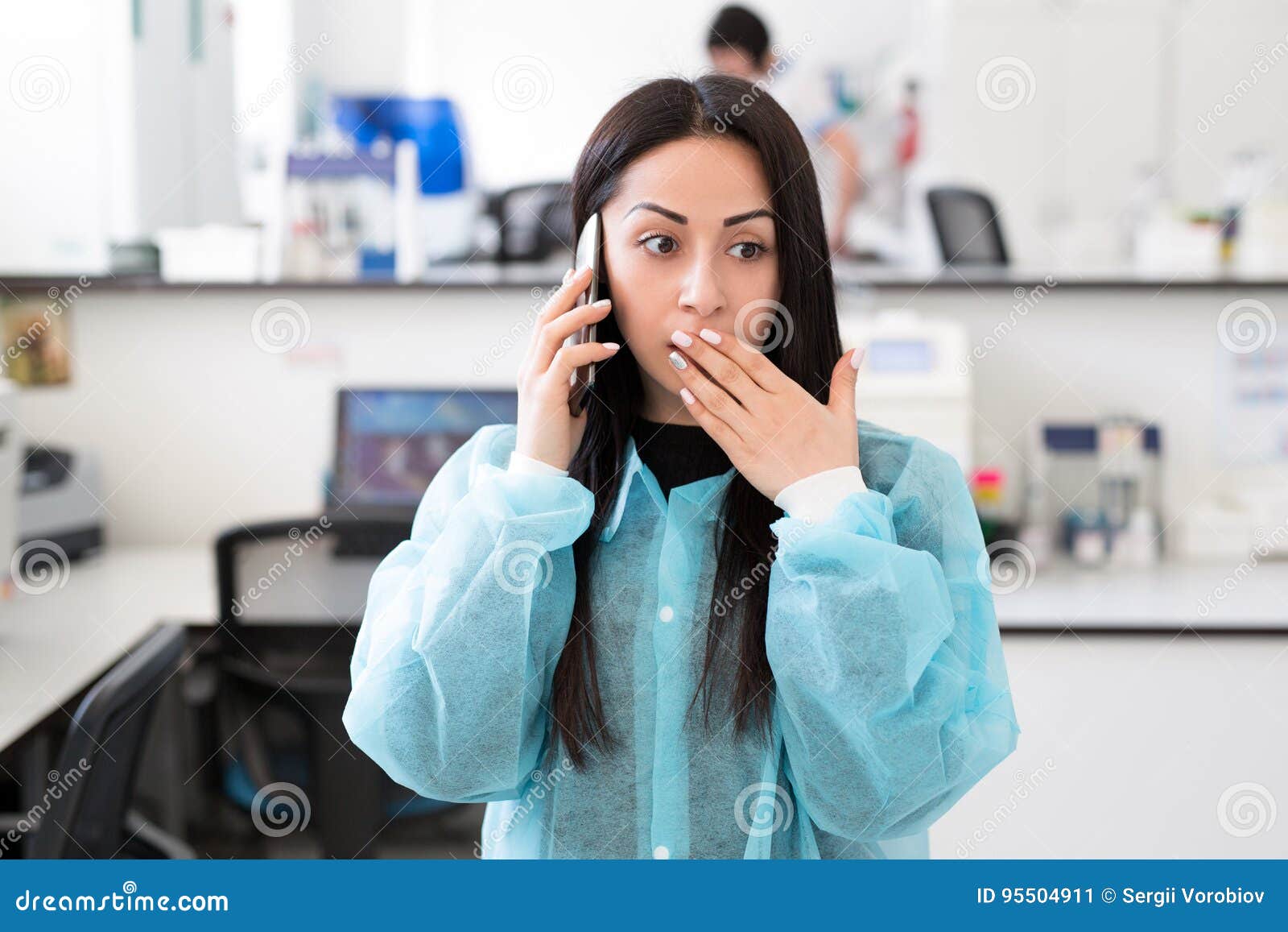 Attractive Female Lab Worker Using Mobile Phone at Her Workplace in the ...
