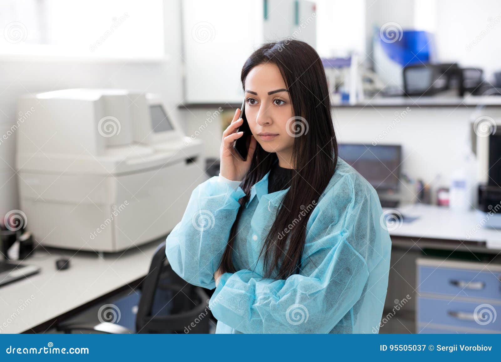 Attractive Female Lab Worker Using Mobile Phone at Her Workplace in the ...