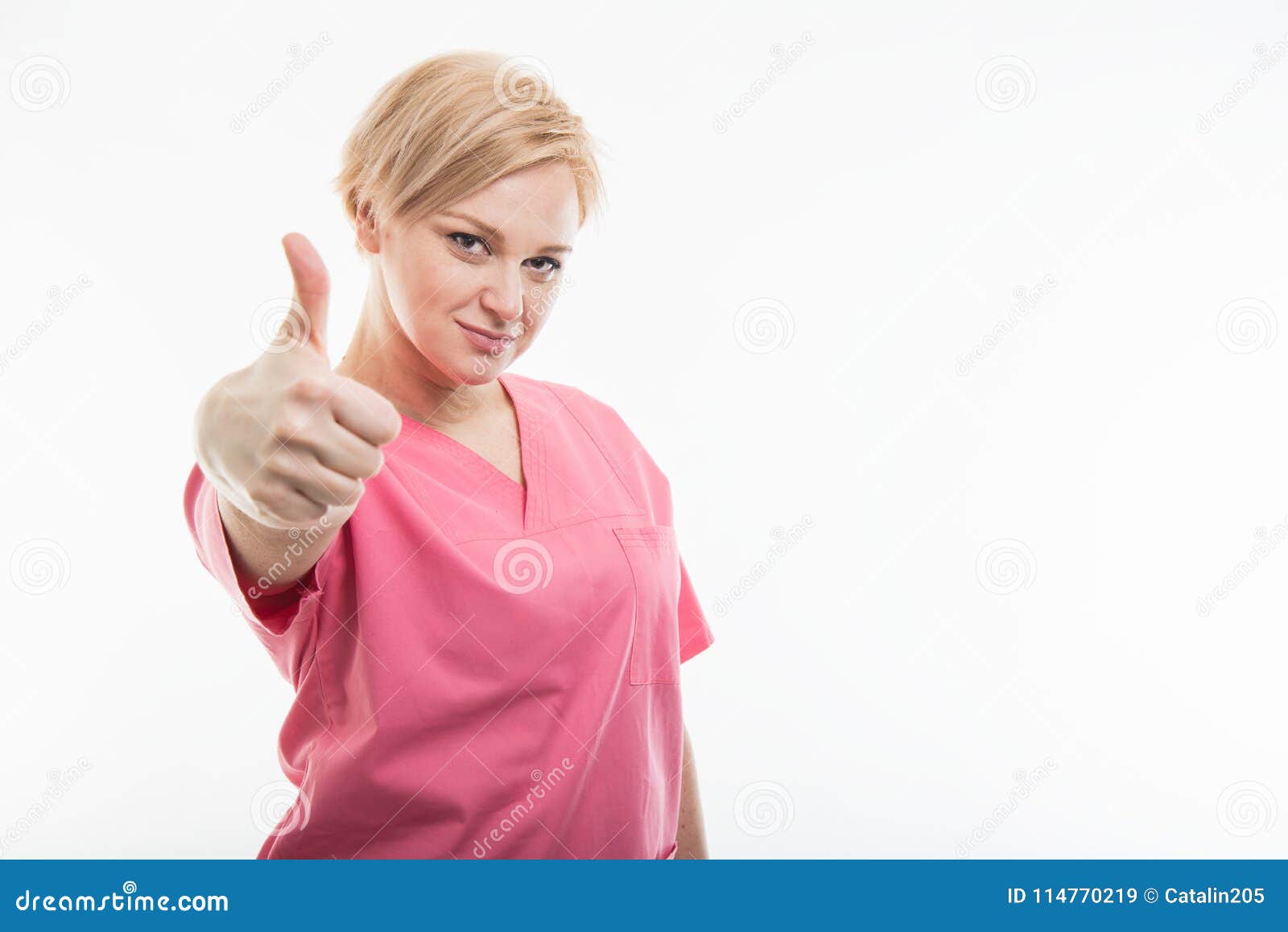Attractive Female Nurse Wearing Pink Scrubs Showing Like Gesture Stock