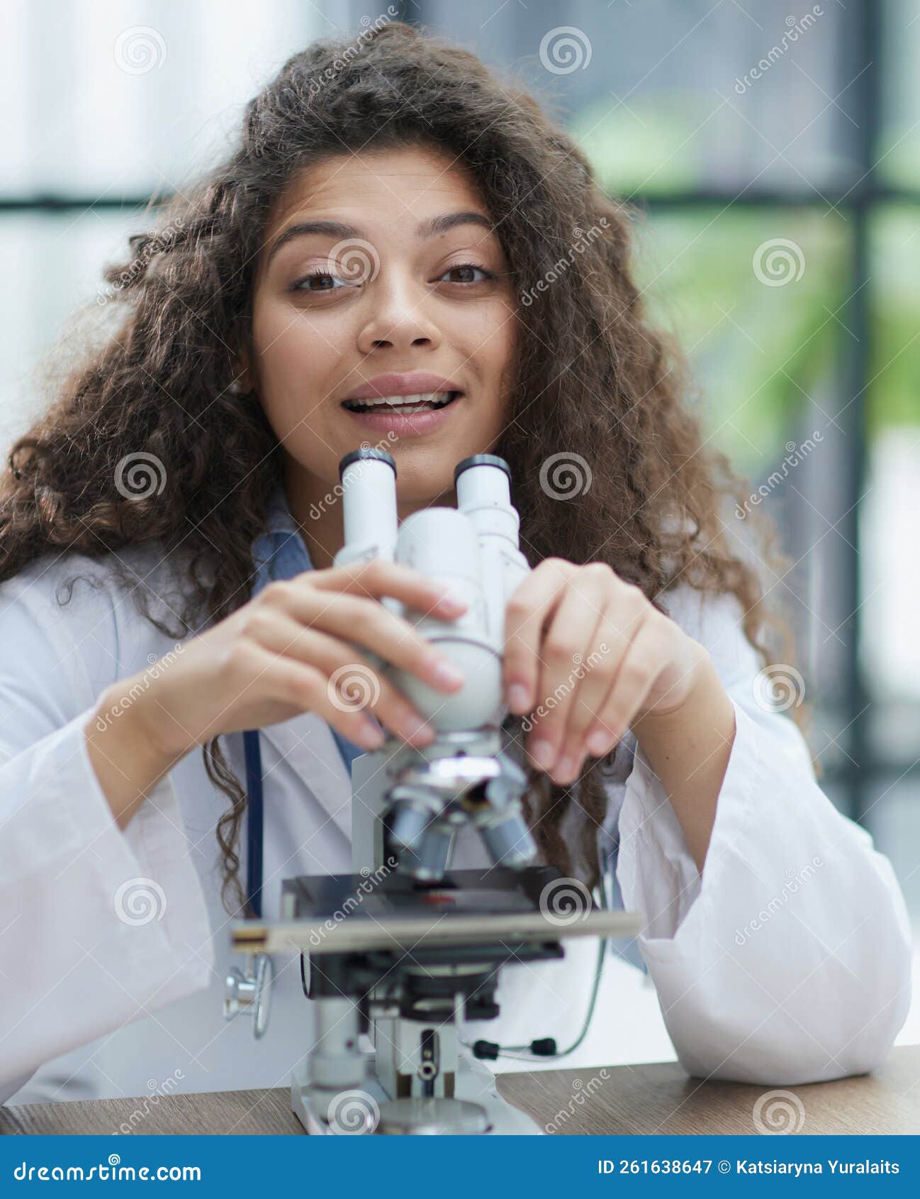 Attractive Female Scientist Looking through a Microscope Stock Image ...