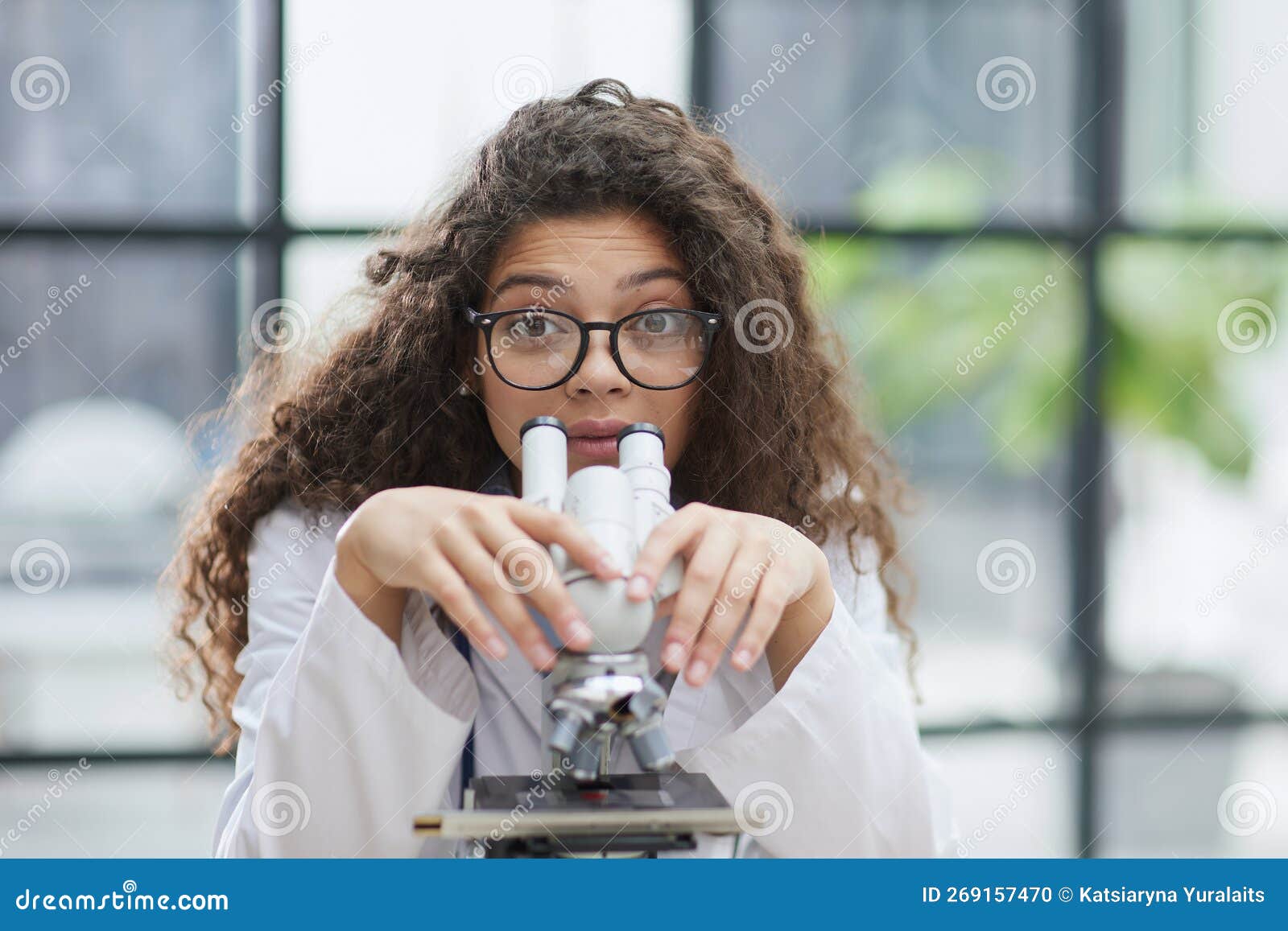 Attractive Female Scientist Looking through a Microscope Stock Photo ...