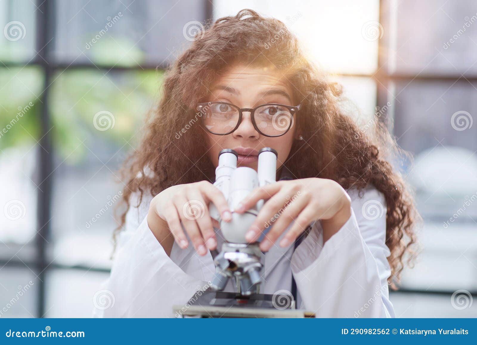 Attractive Female Scientist Looking through a Microscope Stock Photo ...