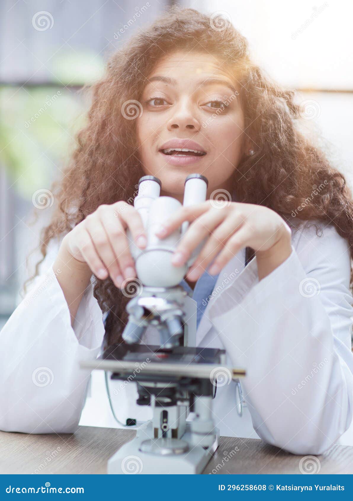 Attractive Female Scientist Looking through a Microscope Stock Photo ...