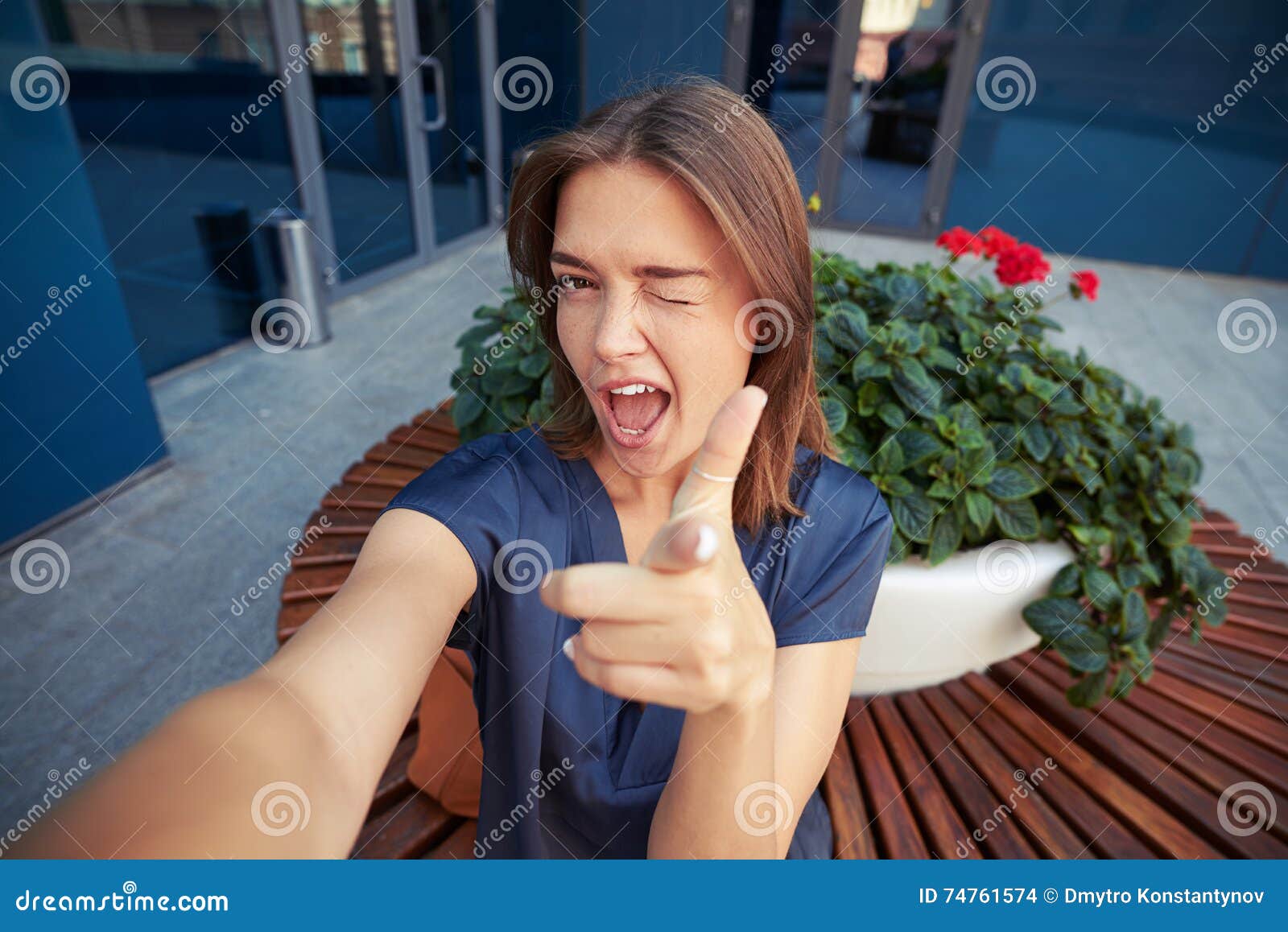 Attractive Female Winking at the Camera while Posing for a Selfie Stock ...