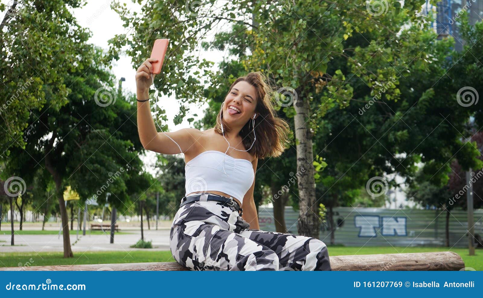 Attractive Female Winking at the Camera while Posing for a Selfie Stock ...