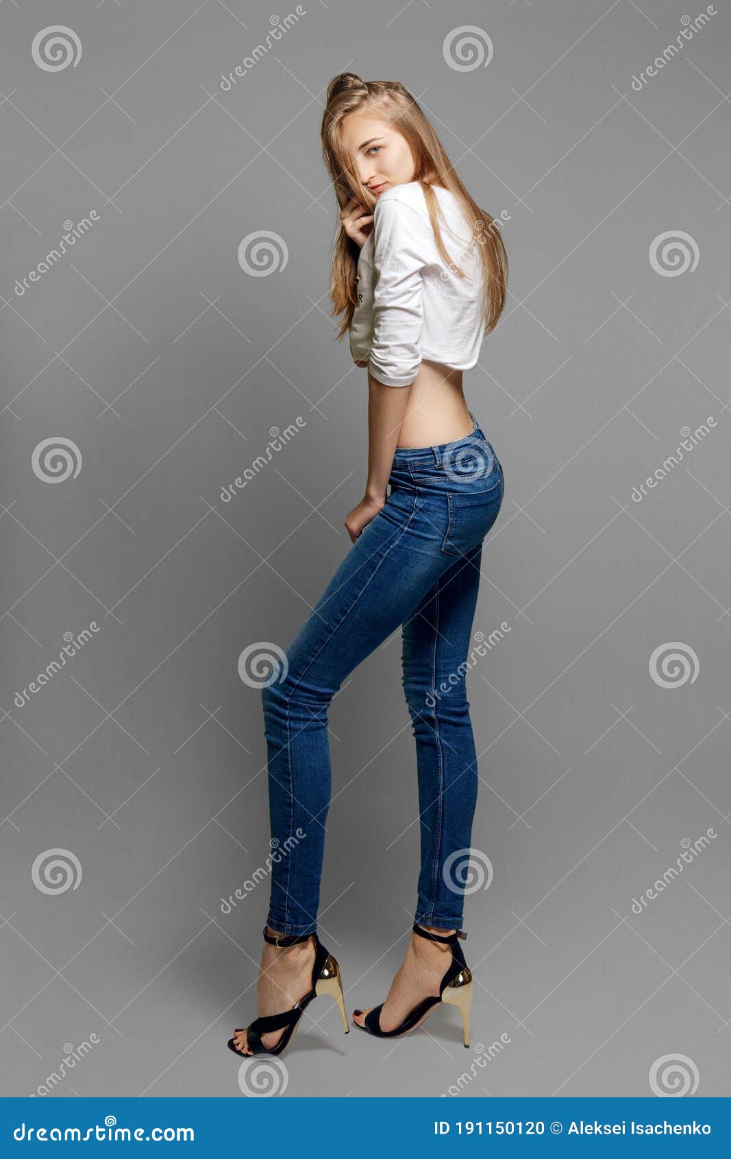 Attractive Fashion Model With Long Slim Legs In Jeans Posing And