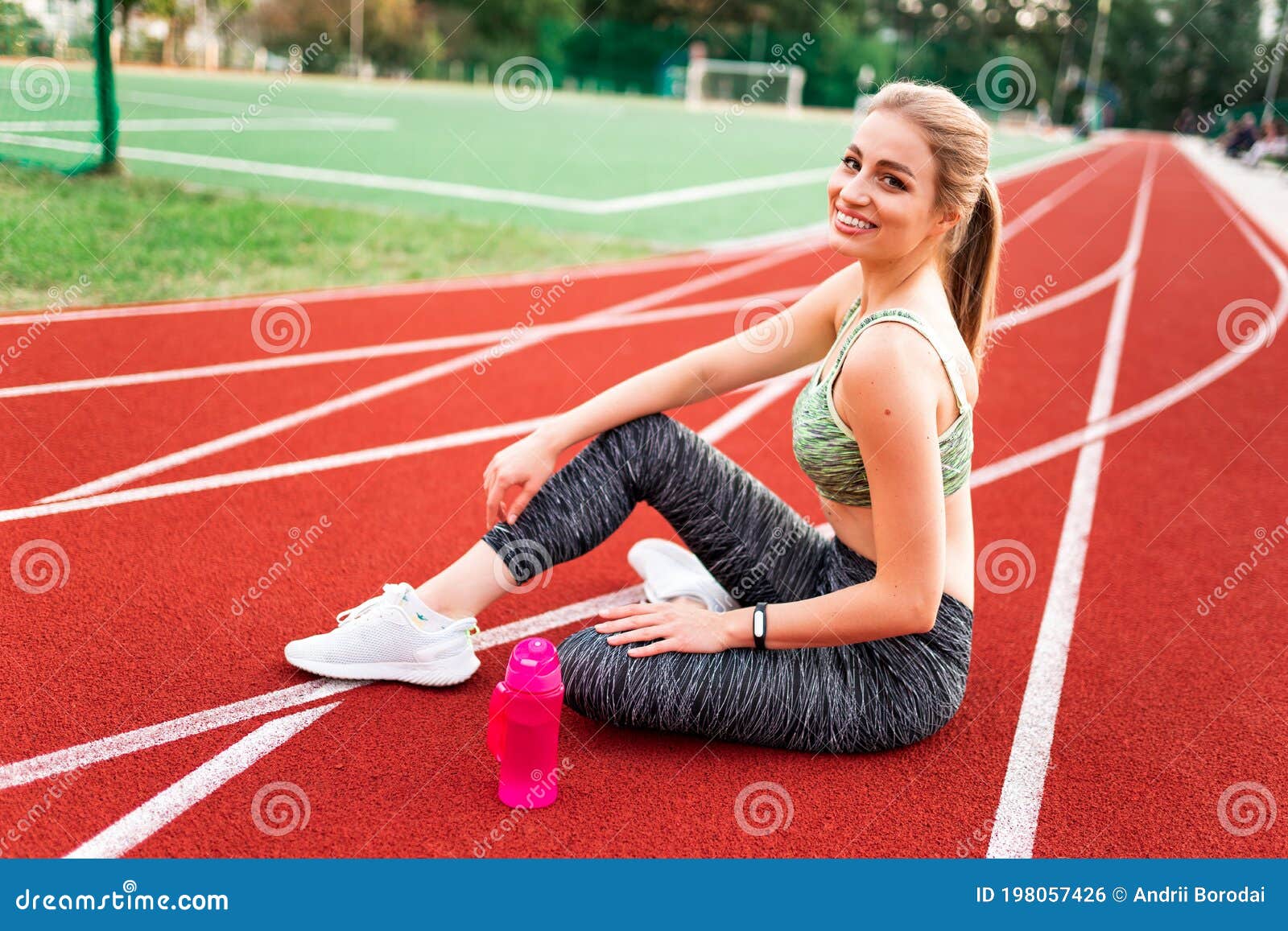 Attractive Girl Sitting on the Running Track. Stock Photo - Image of ...
