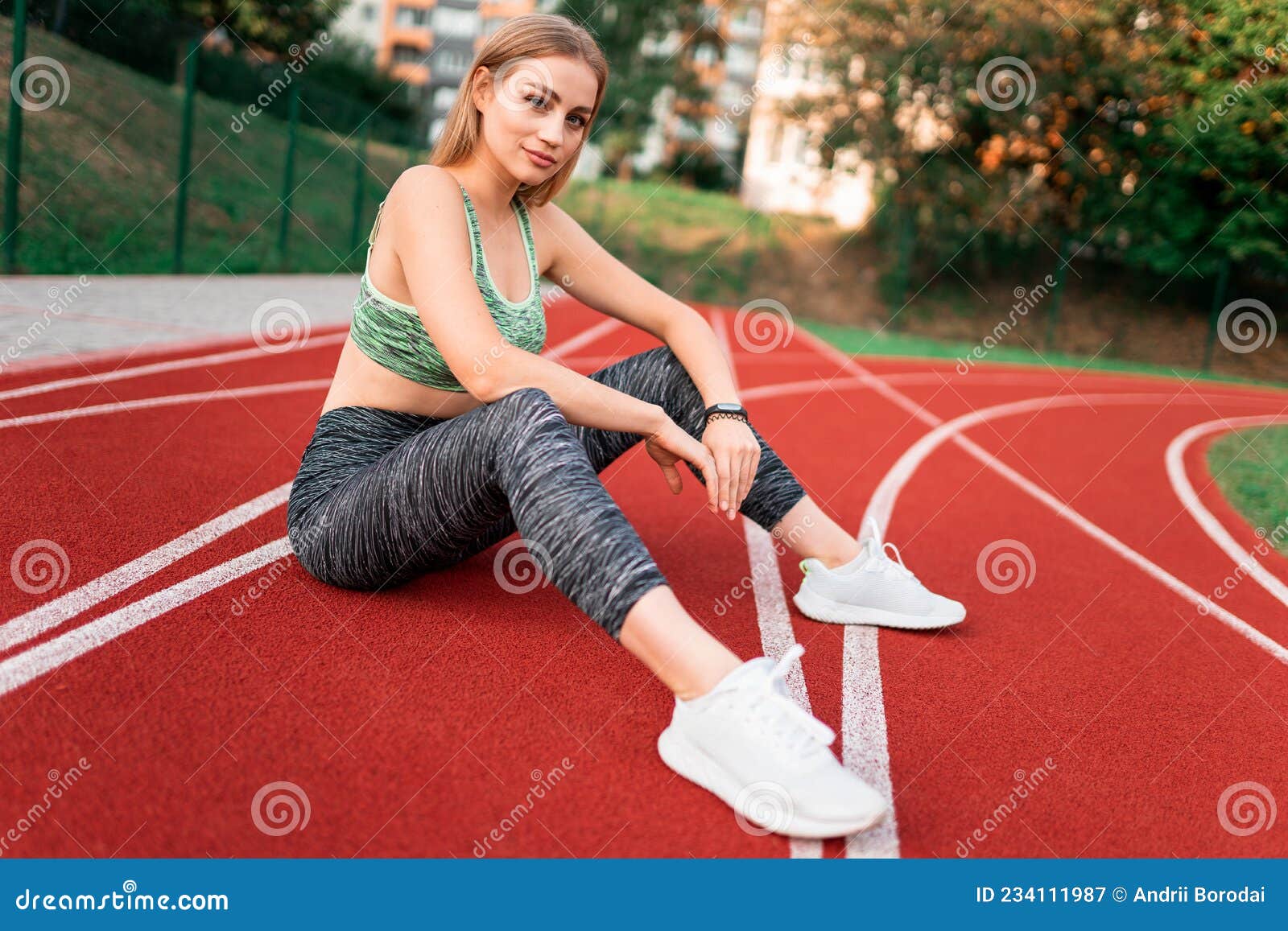 Attractive Girl Sitting on the Running Track. Stock Image - Image of ...