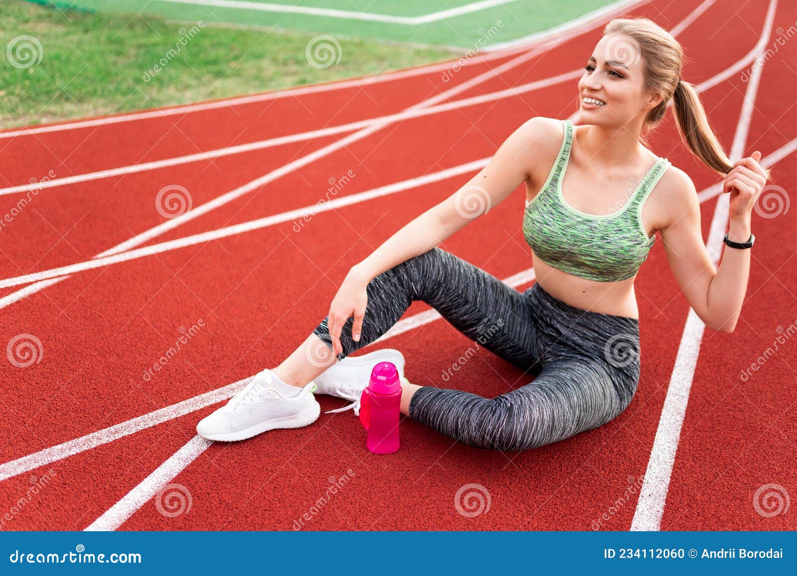 Attractive Girl Sitting on the Running Track. Stock Photo - Image of ...