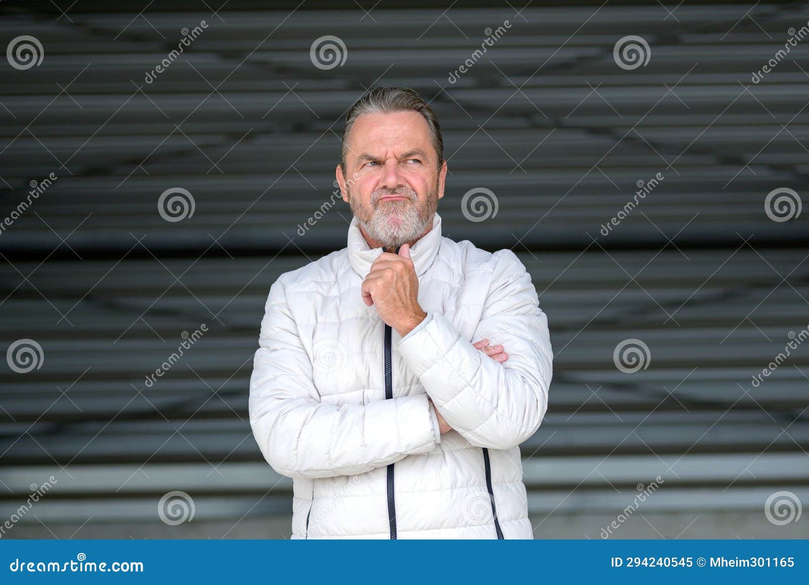 Man with a Hand on His Jacket Looking Grumpy To the Side Stock Image ...