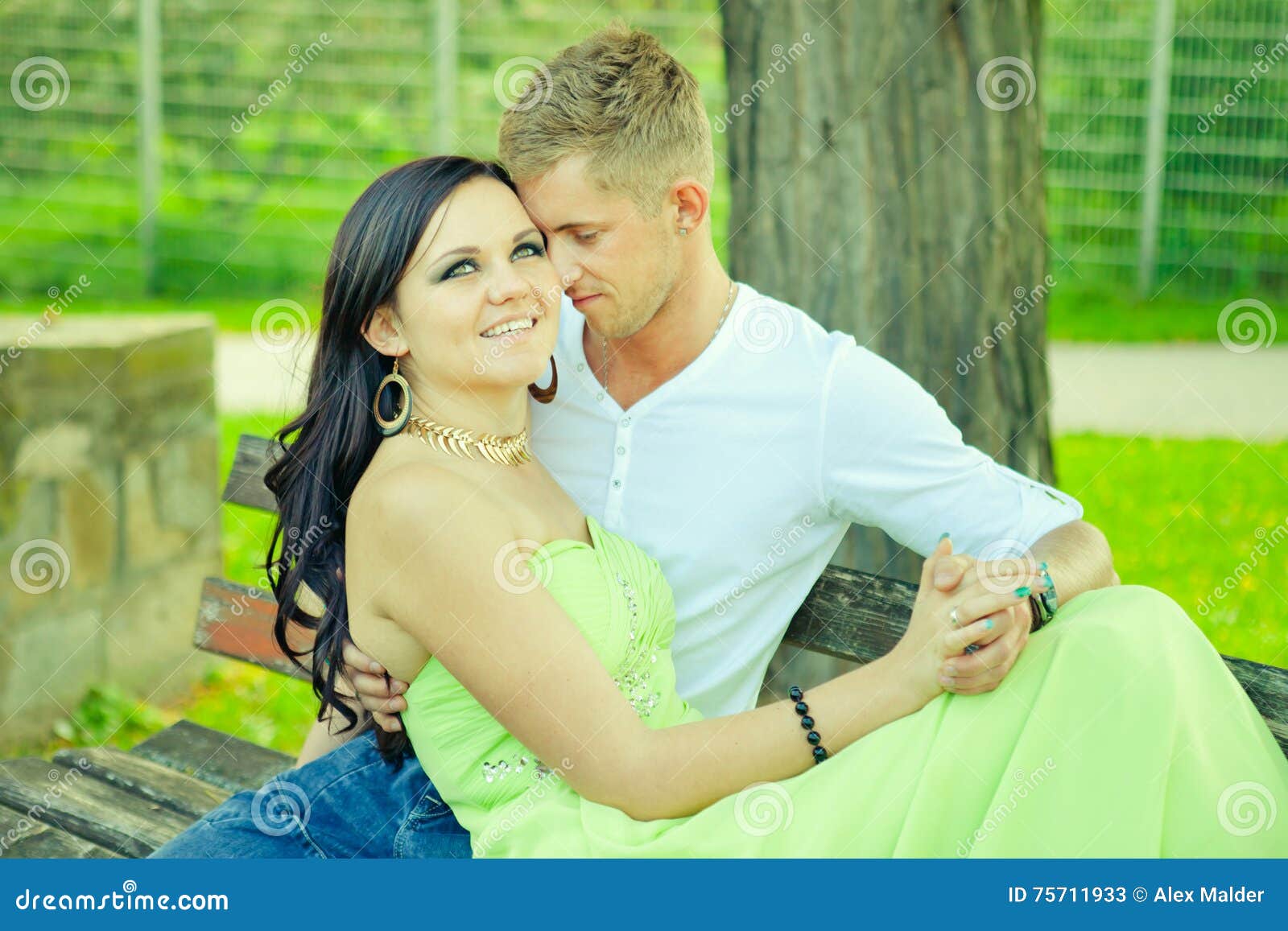 Attractive the Guy with the Girl Sit and Embrace on a Bench Stock Image ...