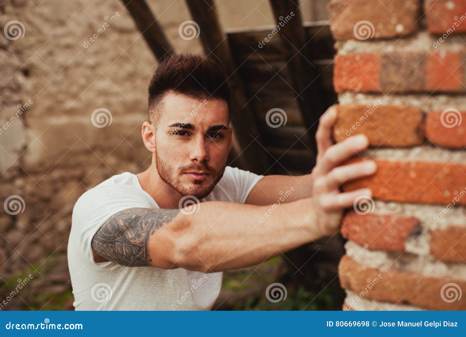 Attractive Guy Next To a Brick Wall Stock Photo - Image of caucasian ...
