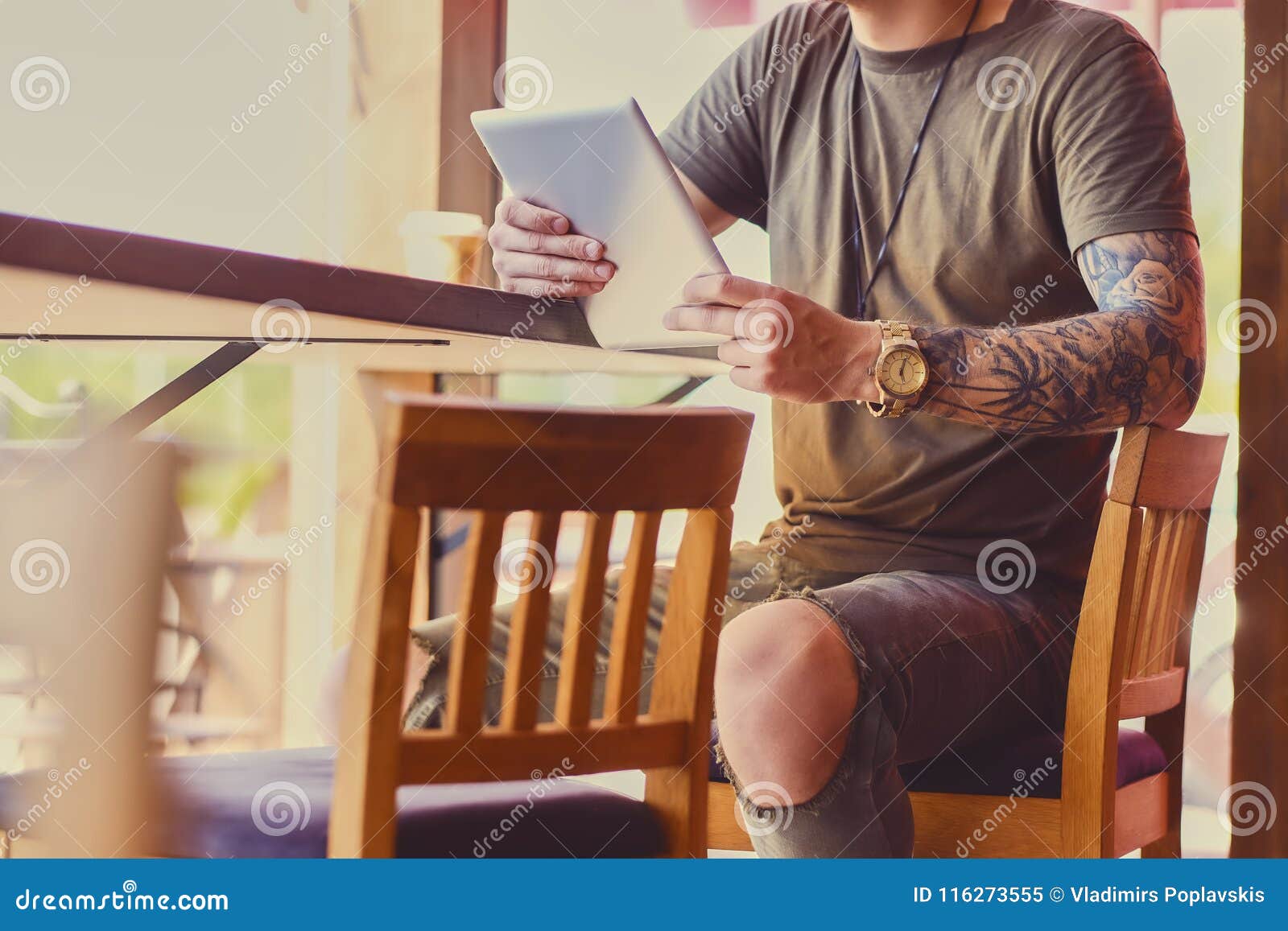 Attractive Guy Using a Tablet PC in a Cafe Near a Window. Stock Image ...