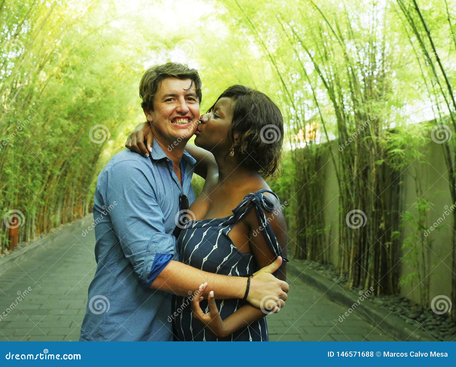Attractive And Happy Mixed Ethnicity Couple Cuddling Outdoors With