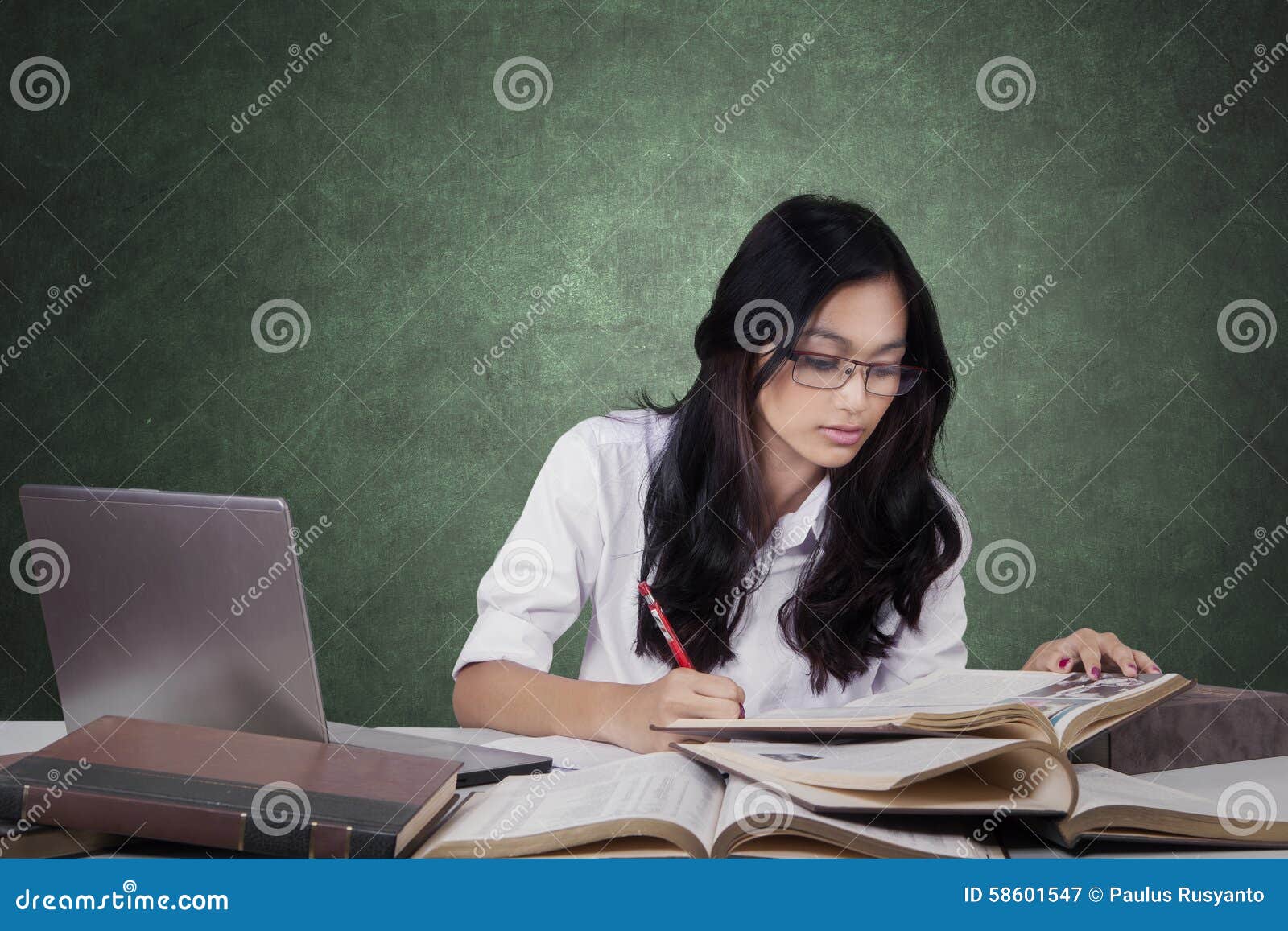 Attractive Learner Writing on the Book in Class Stock Image - Image of ...