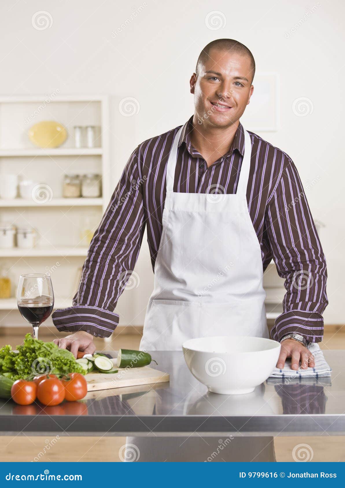 Male Chef Adding Shredded Red Cheddar Cheese On Top Of Dough On A ...