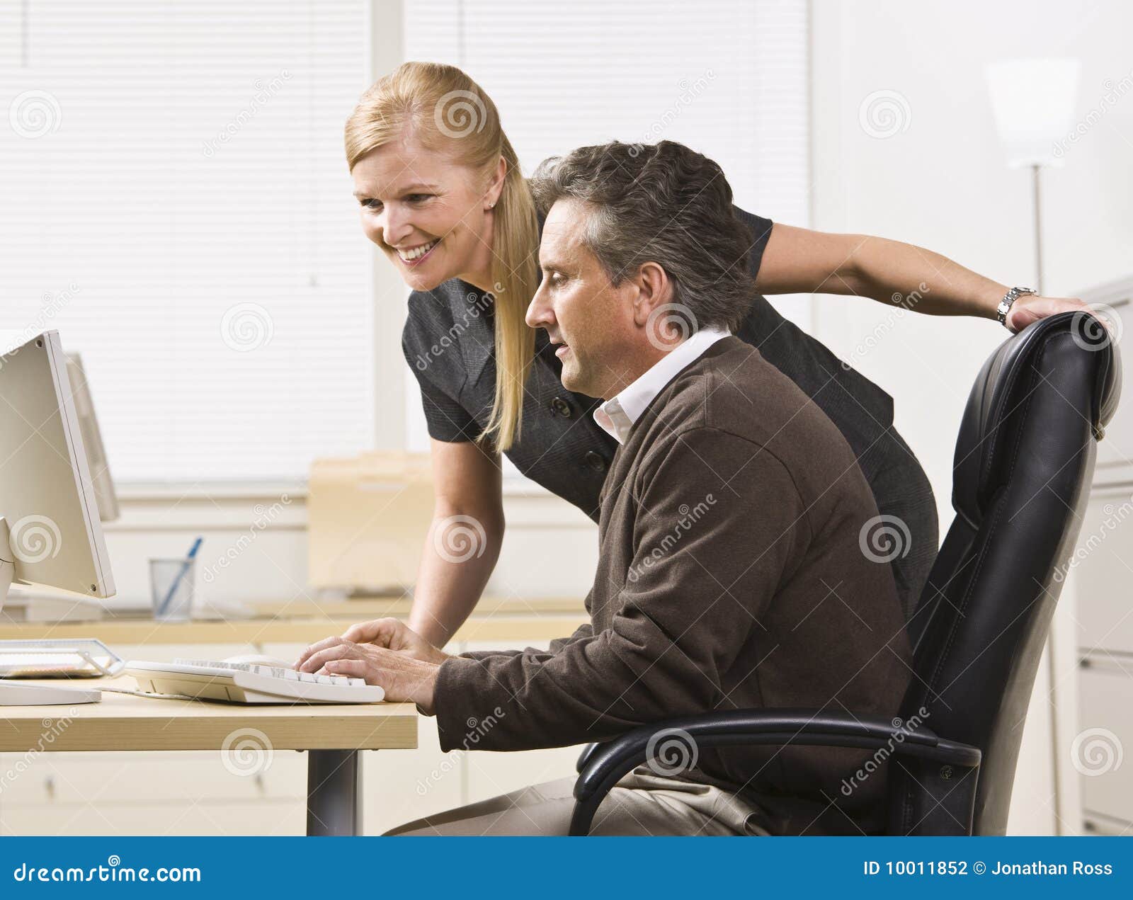 Attractive Male and Female Working on Computer. Stock Photo - Image of ...