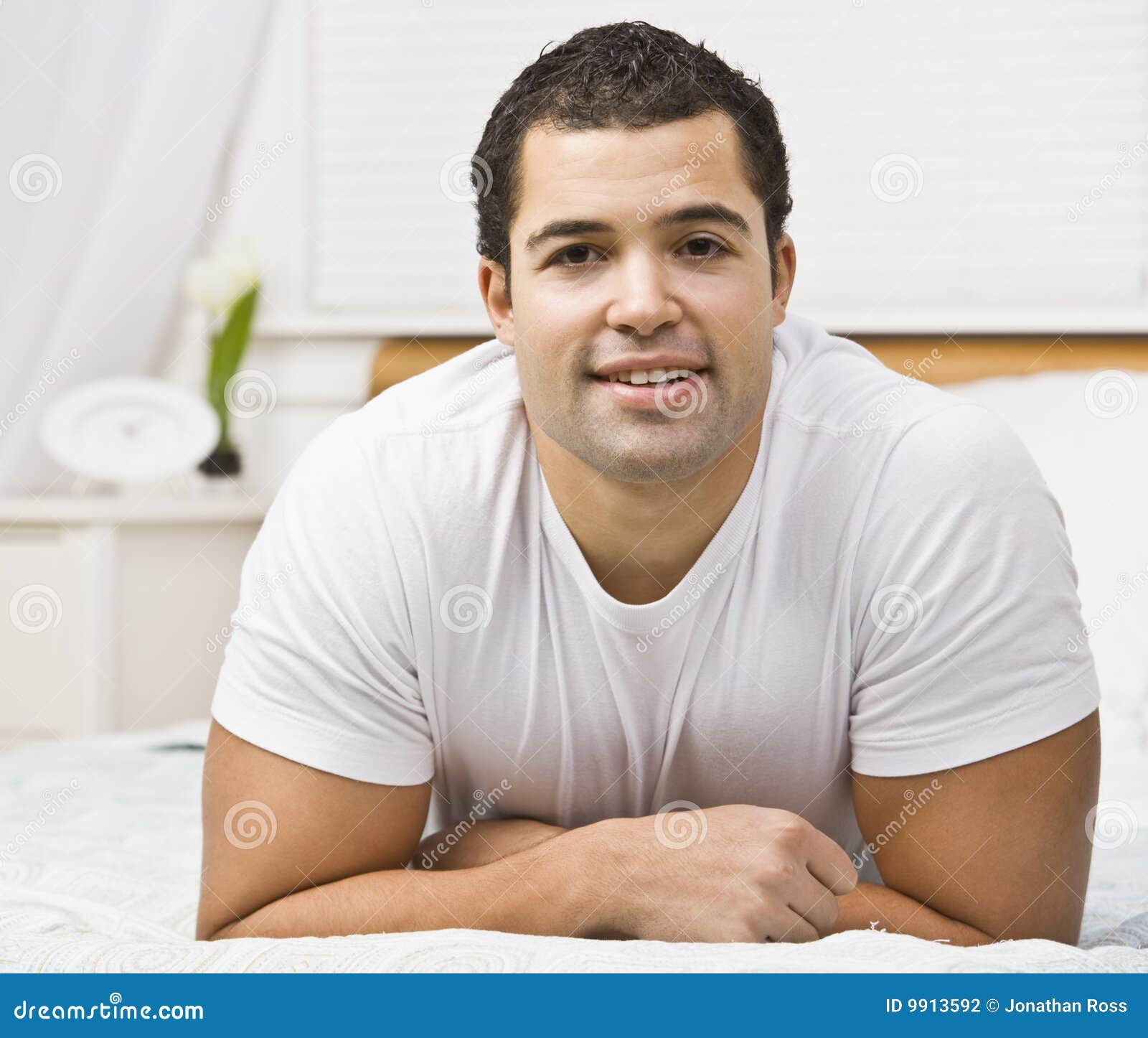 Attractive man on bed stock photo. Image of inside, american - 9913592
