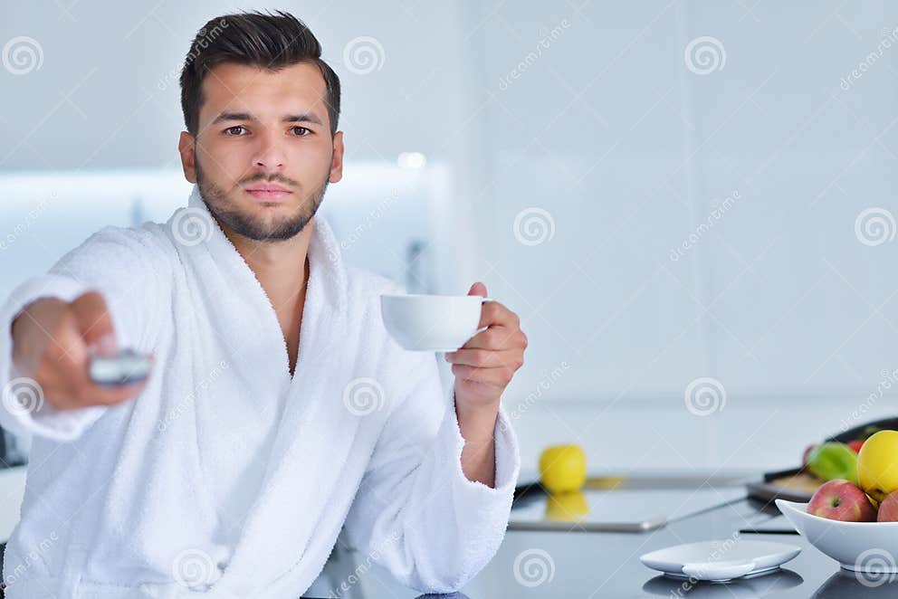 Attractive Man Drinking Coofee and Using Remote Control Stock Photo ...