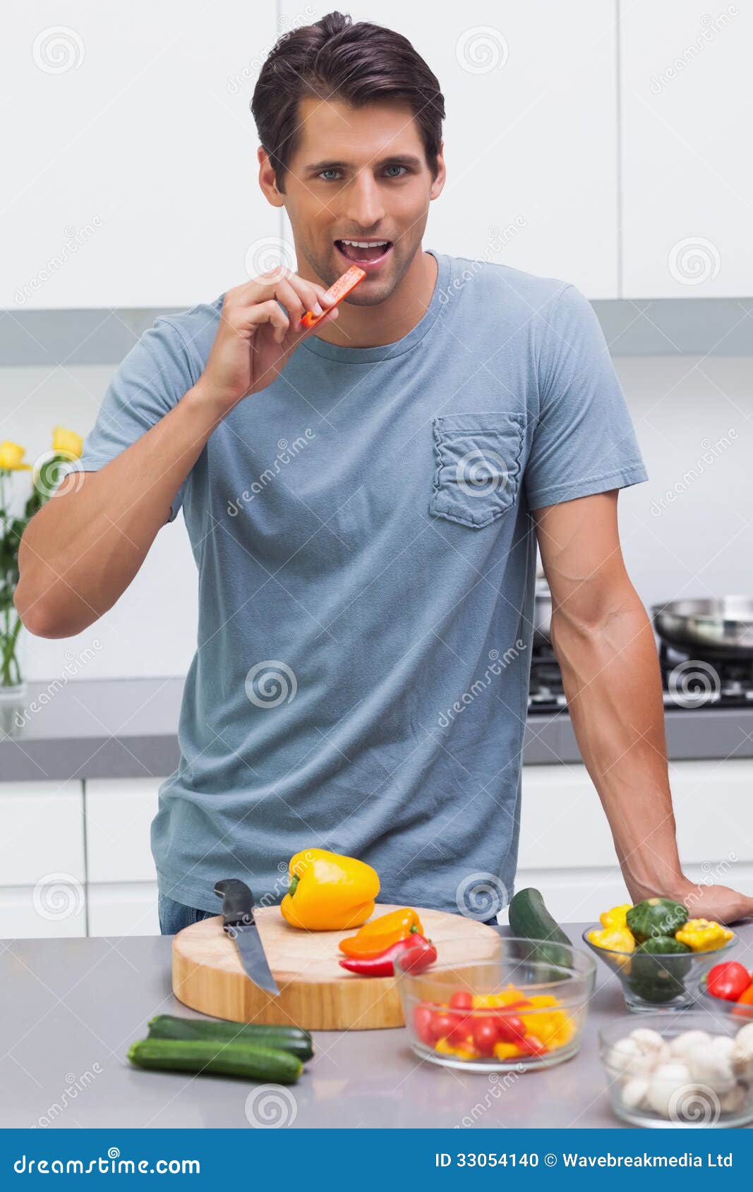 Attractive Man Eating a Slice of Bell Pepper Stock Photo - Image of ...