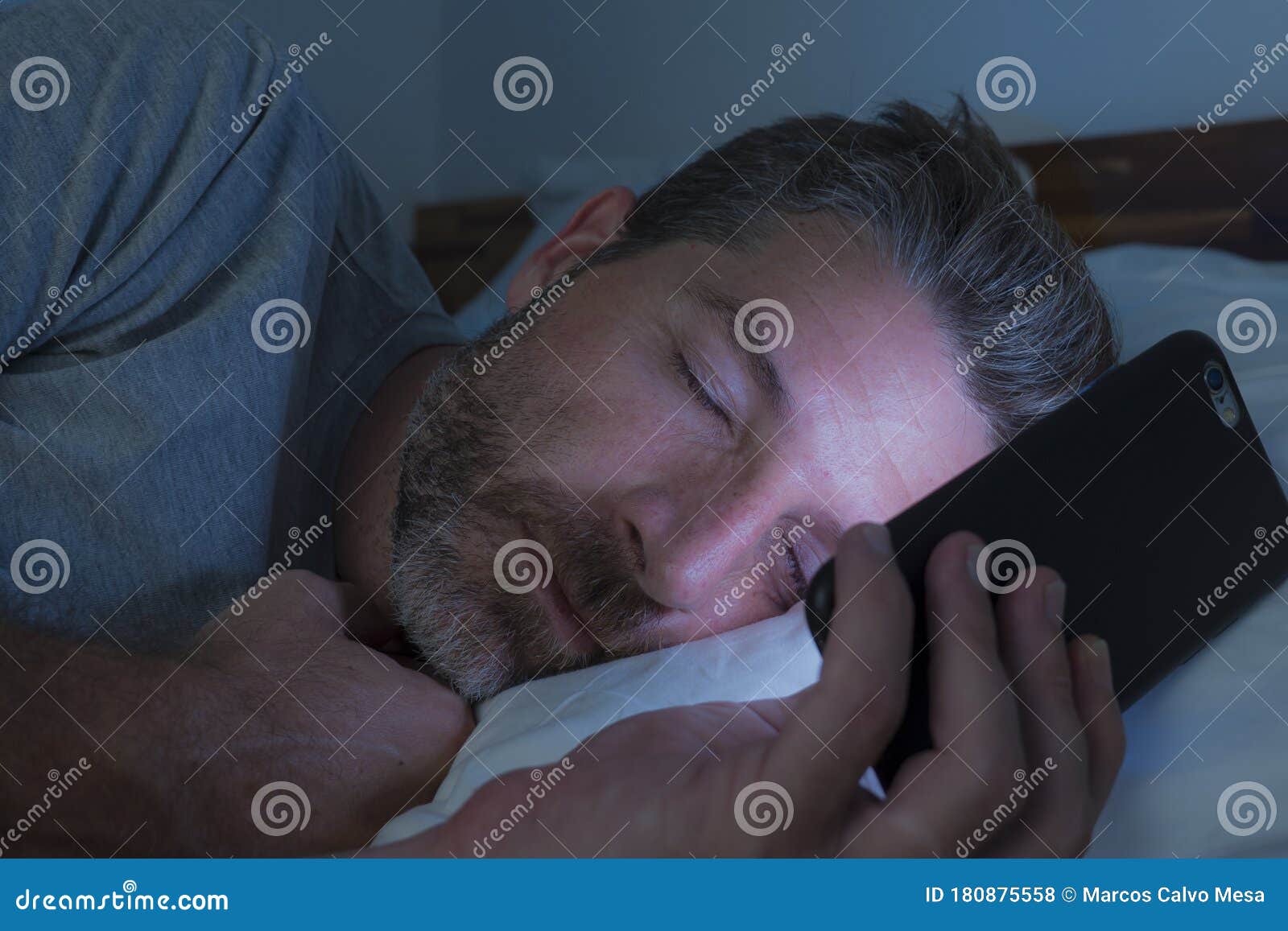 Attractive Man Falling Asleep on Bed Late at Night in Dark Light while ...