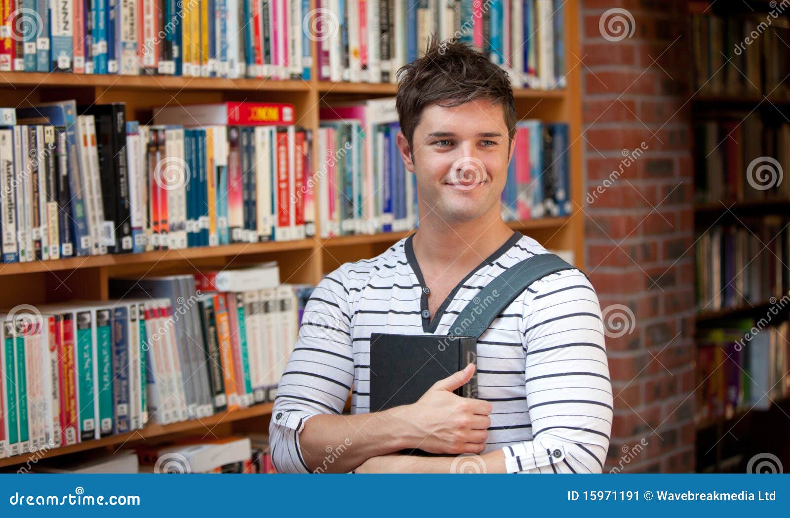 Attractive Man Holding a Book Stock Image - Image of bookshelf, people ...