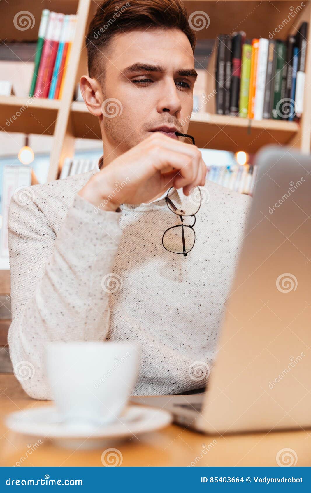 Attractive Man Holding Glasses while Sitting in Cafe Stock Photo ...