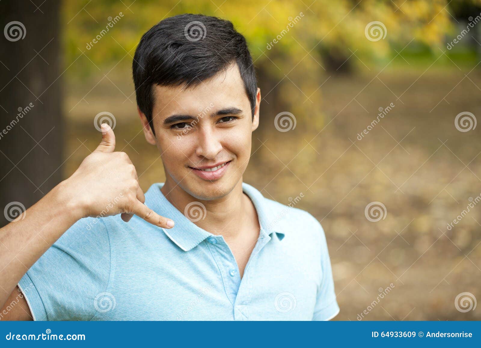 Attractive Man Making a Call Me Gesture, Outdoors Autumn Park Stock ...