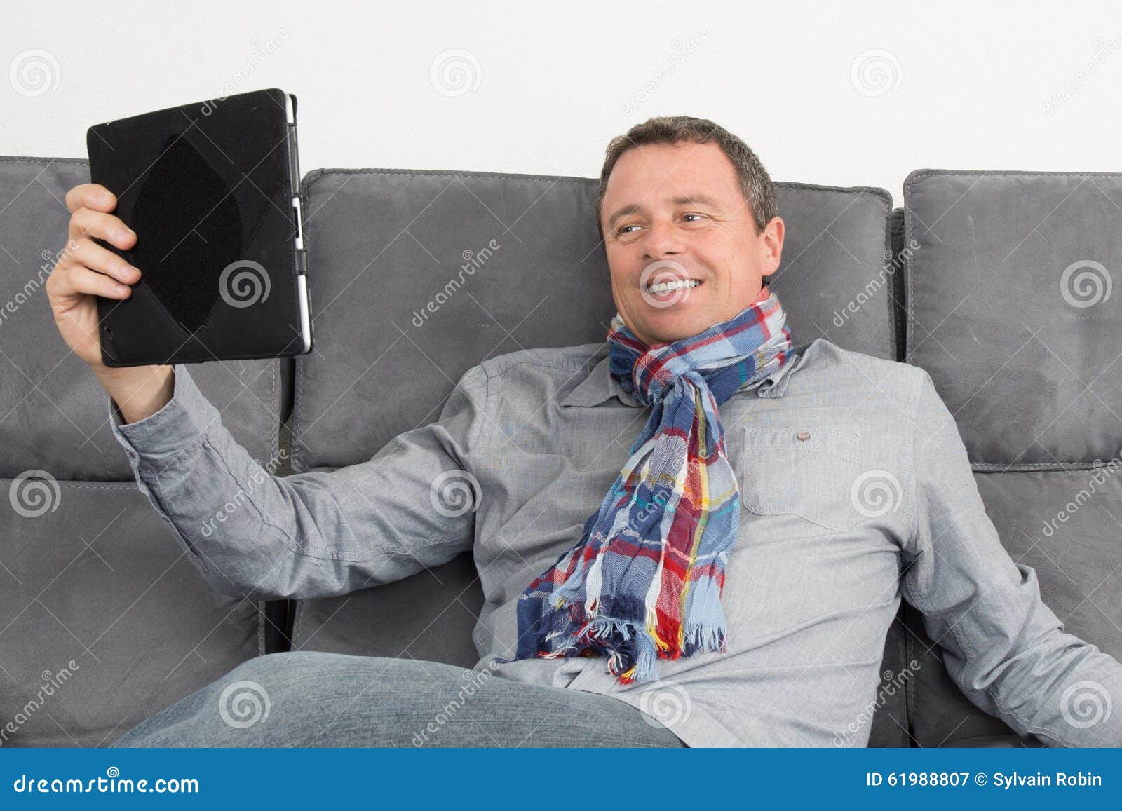 Attractive Man Relaxing on His Couch Stock Image - Image of smart ...