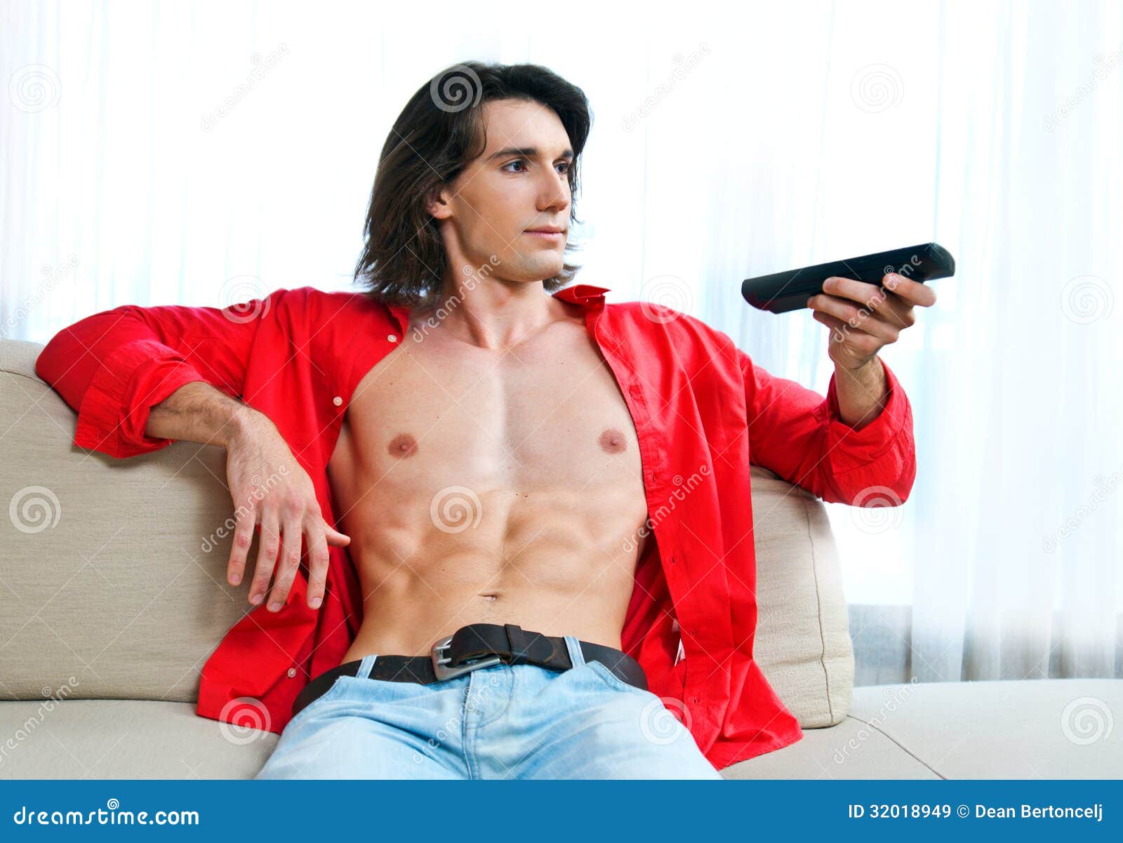 Attractive man on the sofa stock image. Image of pose - 32018949