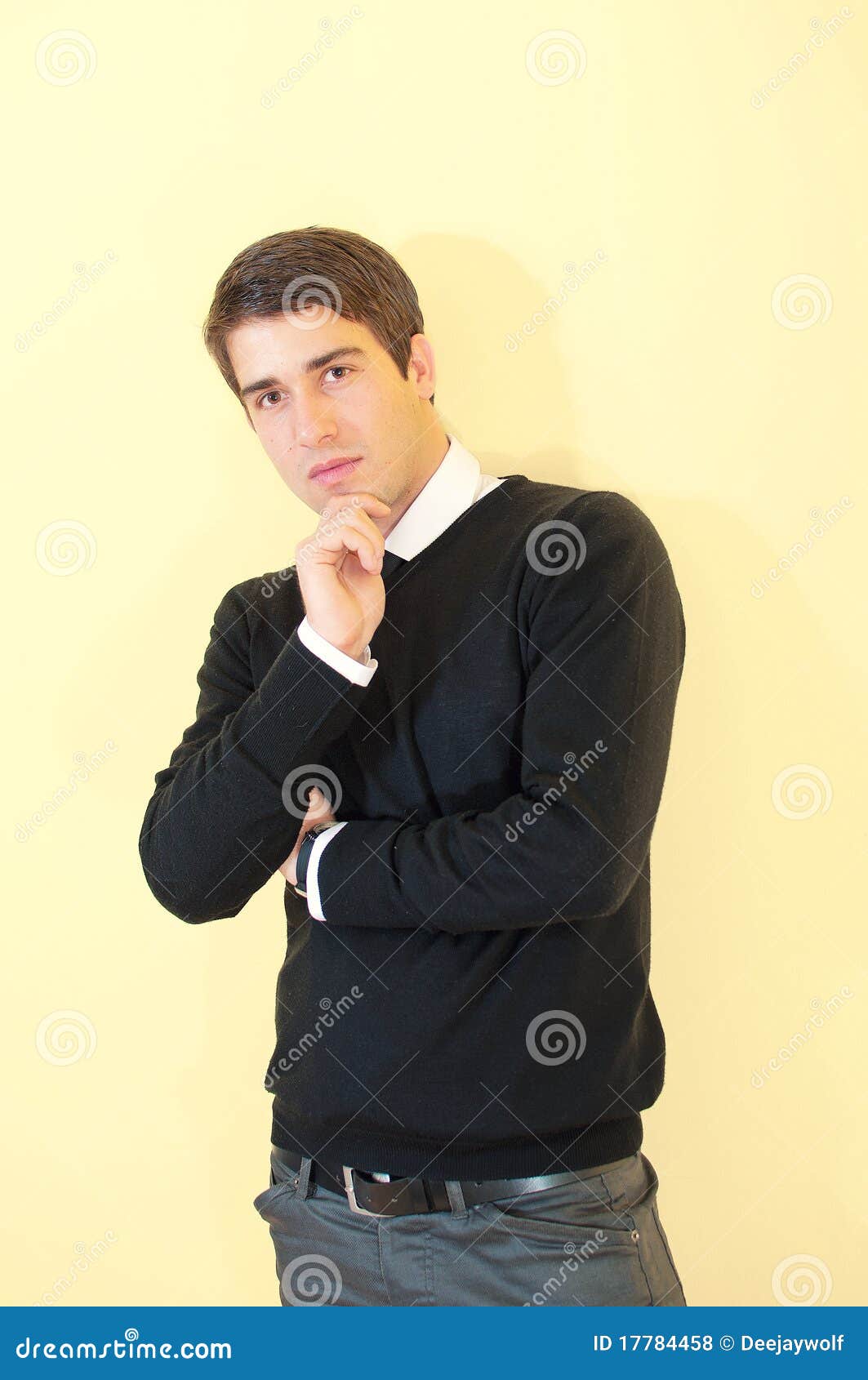 Attractive Man Standing and Thinking Against Wall Stock Photo - Image ...