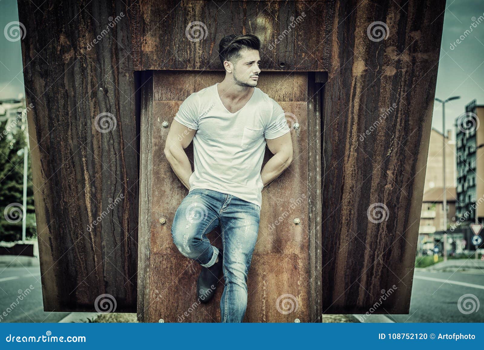 Man in Urban Setting in Front of Big Metal Structure Stock Photo ...