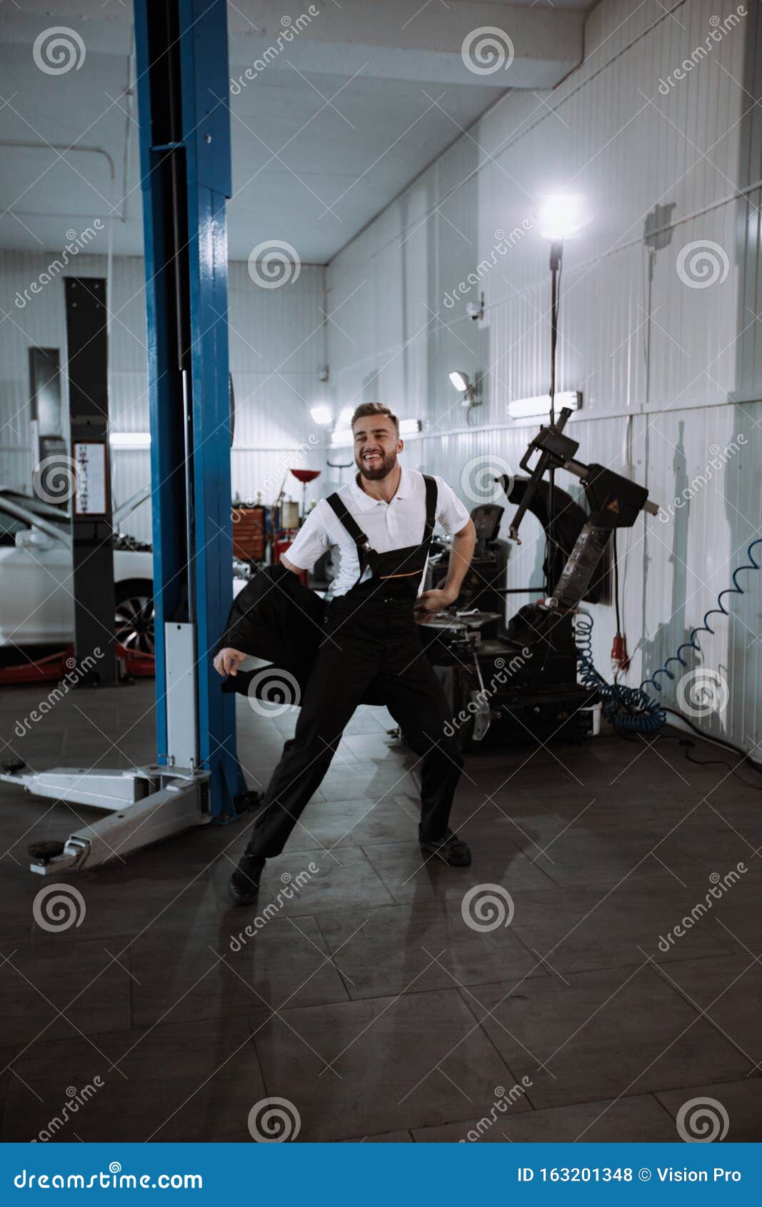 Attractive Mechanic Man in a Modern Service Center Dancing Funny in ...