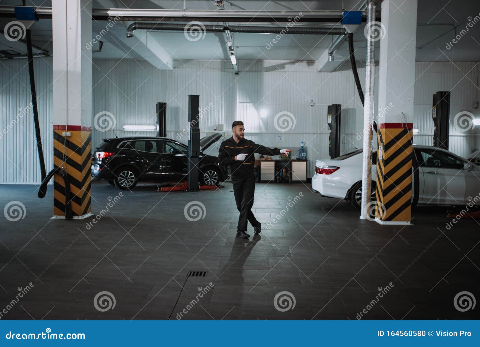 Attractive Mechanic Man in a Modern Service Center Dancing Funny in ...