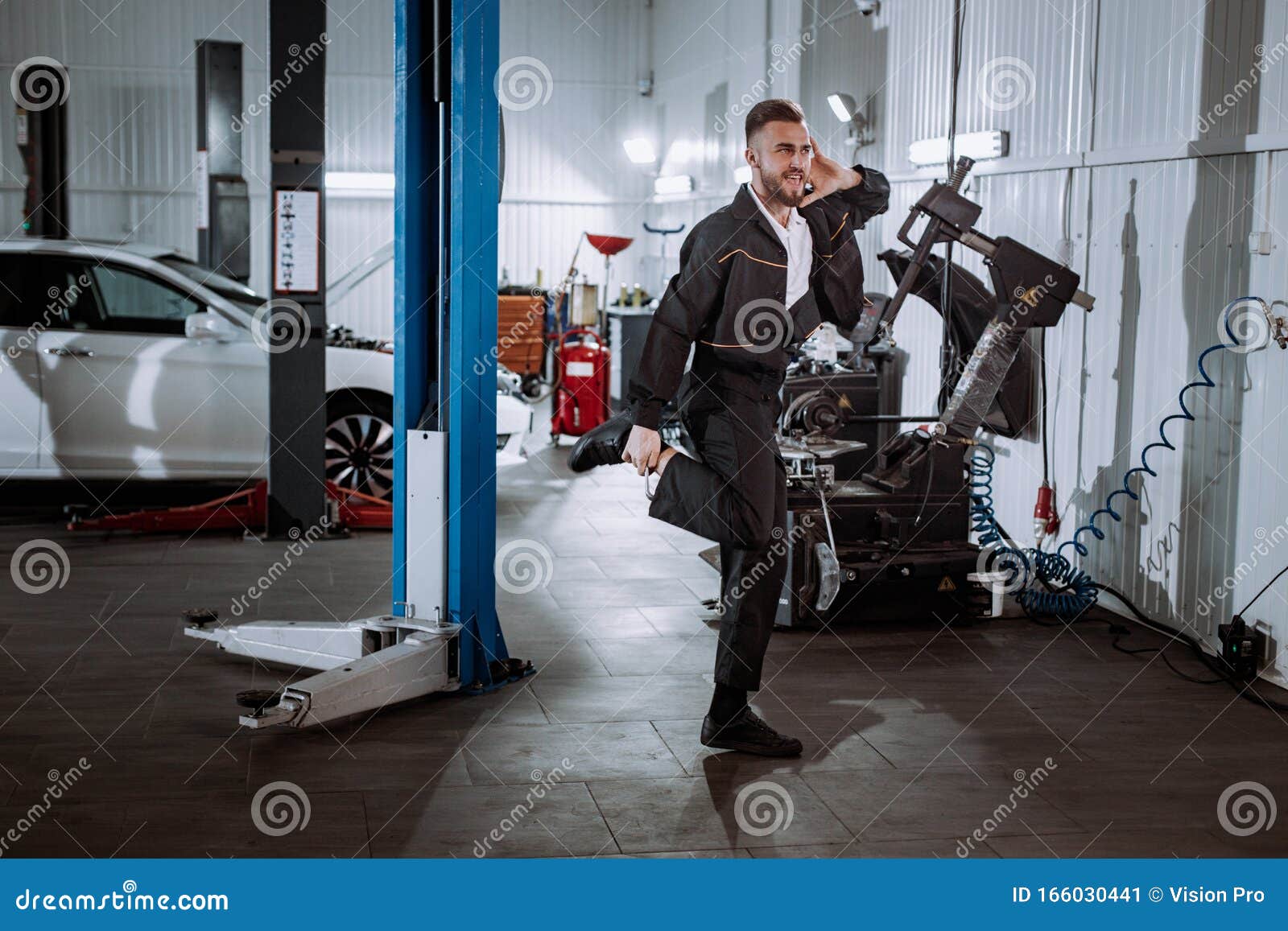 Attractive Mechanic Man in a Modern Service Center Dancing Funny in ...