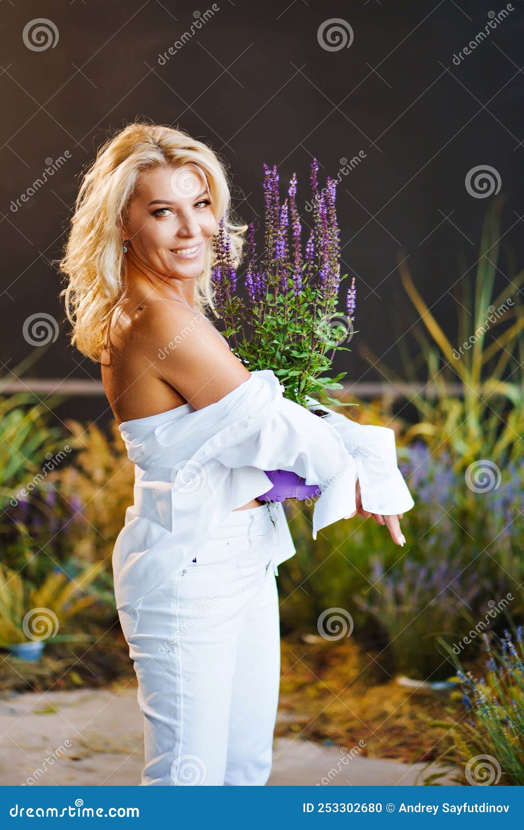 An Attractive Middle Aged Blonde Woman Topless In A White Shirt With