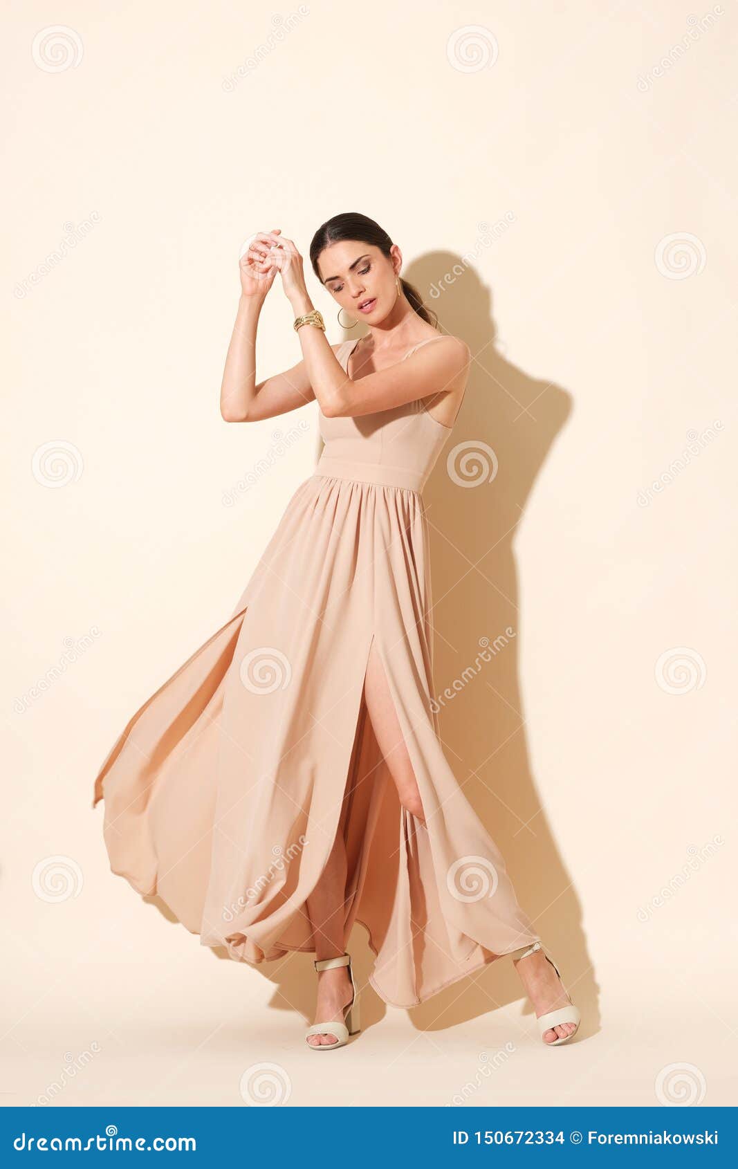 Attractive Model in Long Dress Posing in Studio. Stock Photo - Image of ...