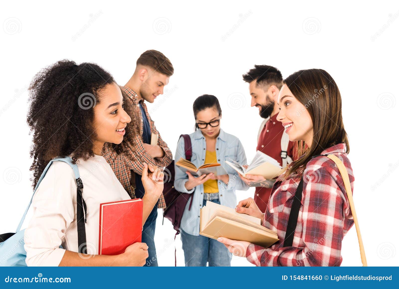 Attractive Multiethnic Girls Talking with Books in Hands Near Group of ... Attractive Multiethnic Girls Talking with Books in Hands Near Group of ...