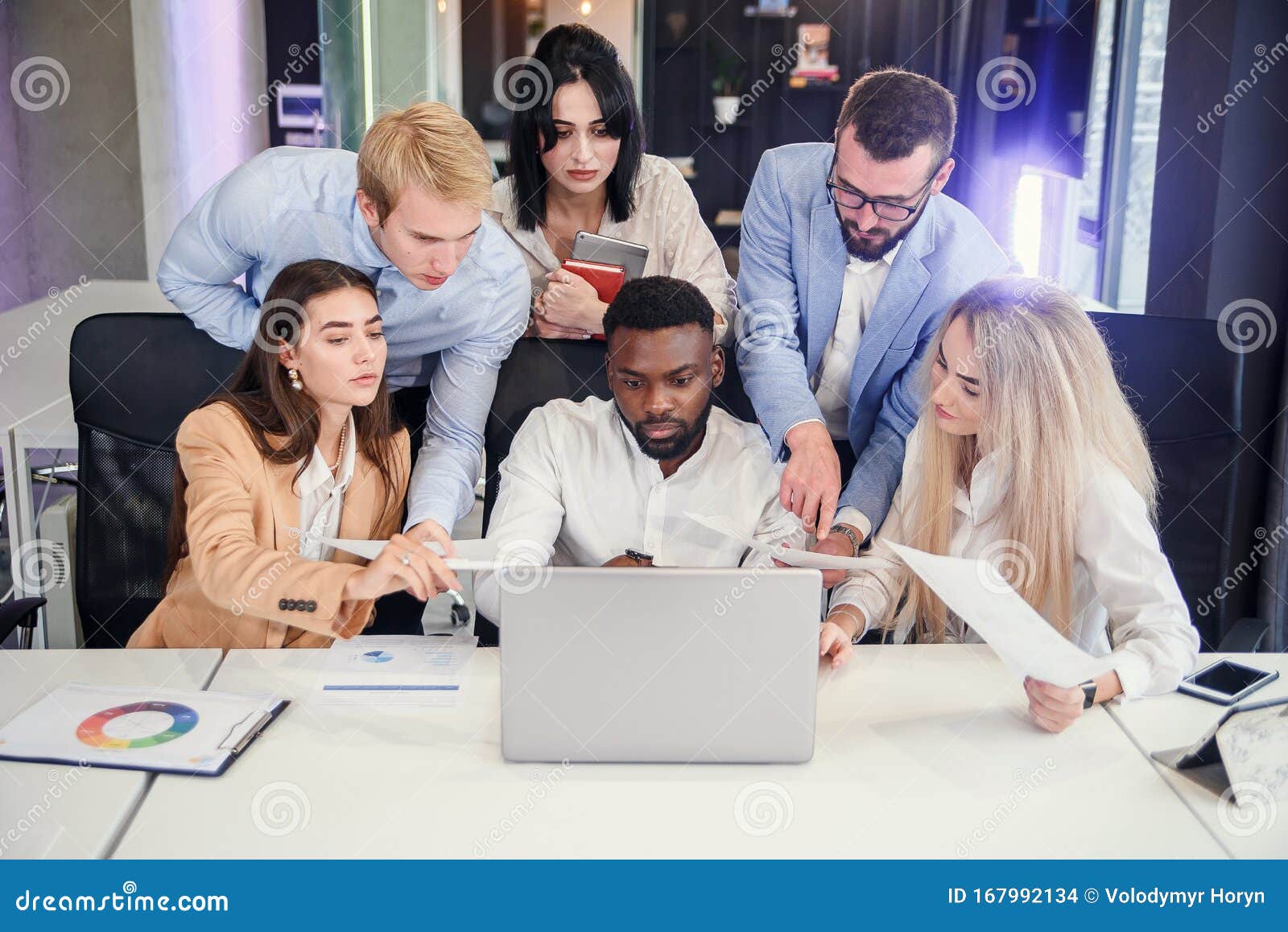 Attractive Multiracial Office Managers Discussing Their Business Plan ...