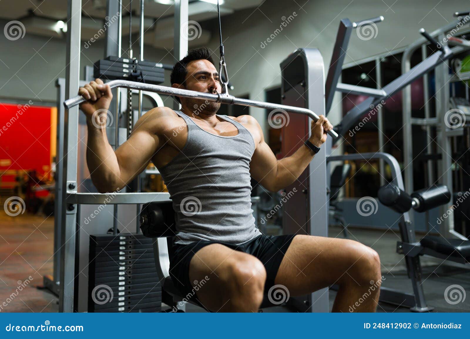 Strong Young Man Working Out Stock Photo - Image of machine, fitness ...