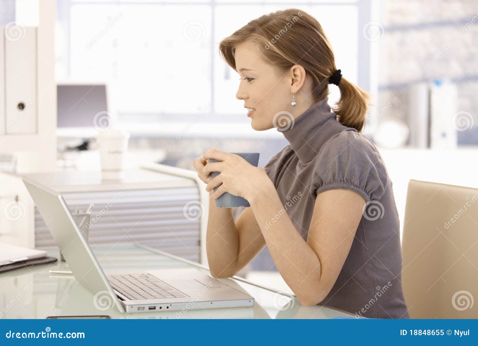 Attractive Office Worker Drinking Tea At Desk Royalty-Free Stock Photo ...