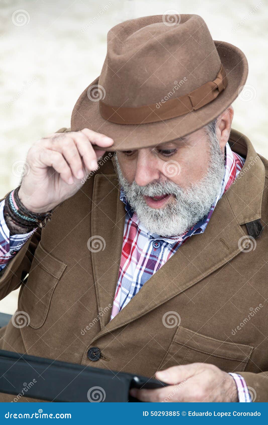 Attractive Old Man With Beard And Hat With A Tablet Stock Image Image