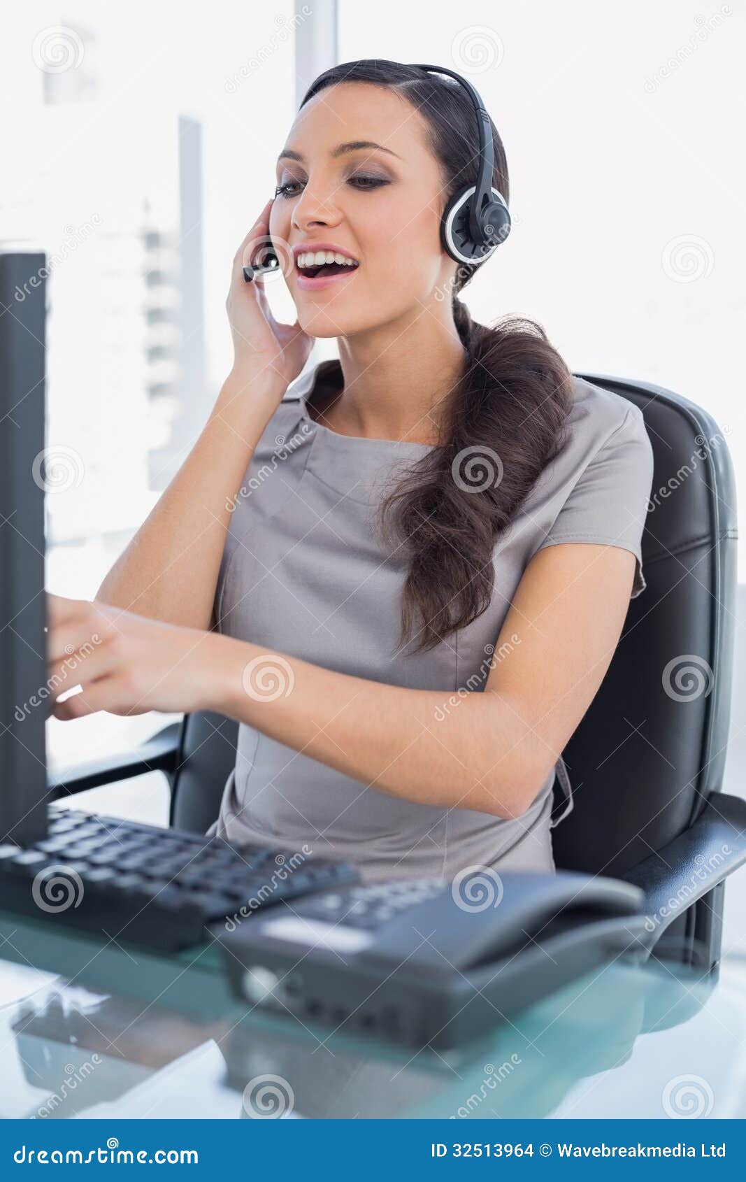 Attractive Secretary Wearing Headset and Pointing at Computer Sc Stock ...